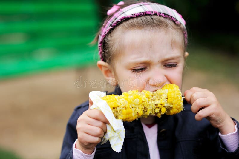 Litle Girl Eating Corn on the Cob Stock Photo - Image of face, food ...