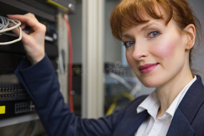 Pretty Computer Technician Smiling at Camera while Fixing Server Stock ...