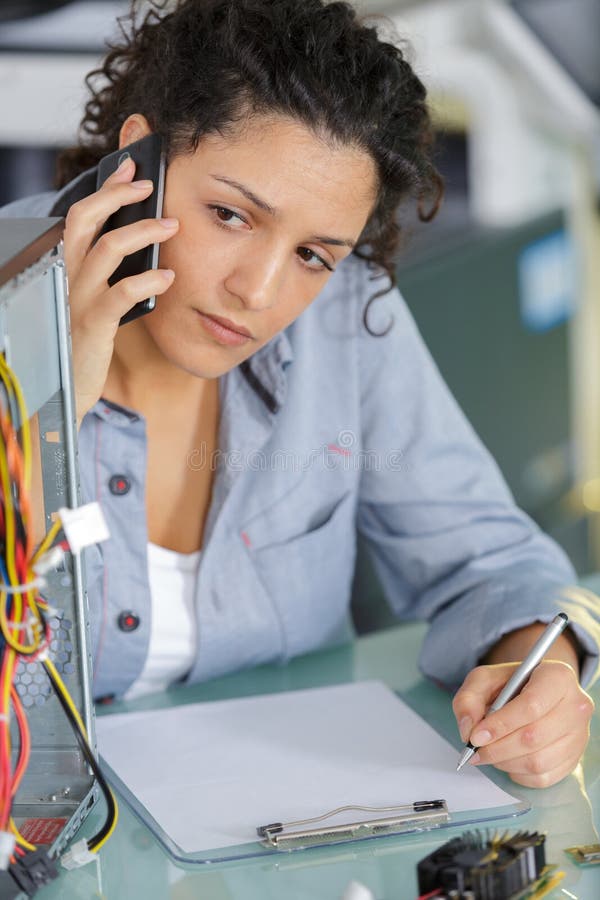 Pretty Computer Technician Talking on Phone while Fixing Server Stock ...