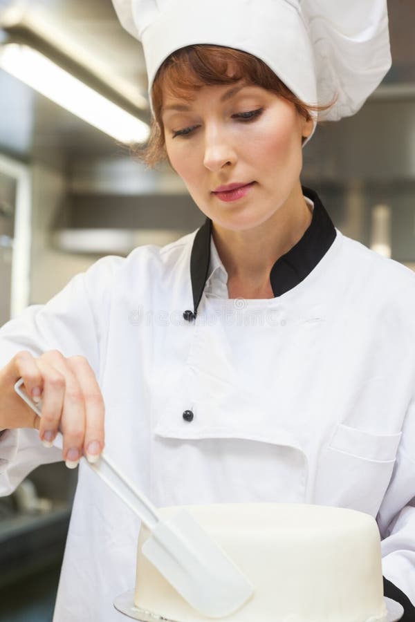 Pretty Concentrating Head Chef Finishing a Cake with Icing Stock Image ...