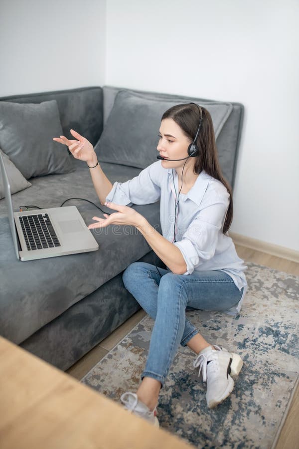 A Pretty Dark-haired Operator of Call Canter Working from Home Stock ...