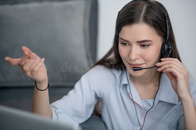 A Pretty Dark-haired Operator of Call Canter Working from Home Stock ...