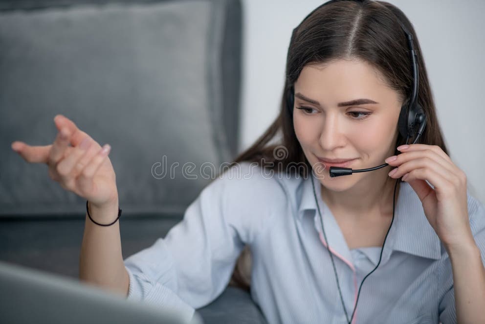 A Pretty Dark-haired Operator of Call Canter Working from Home Stock ...