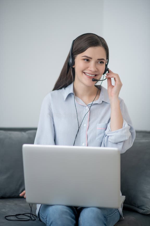 A Pretty Dark-haired Operator of Call Canter Working from Home Stock ...