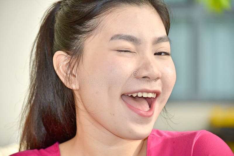 A Pretty Diverse Female Winking Stock Photo - Image of winking, pretty ...