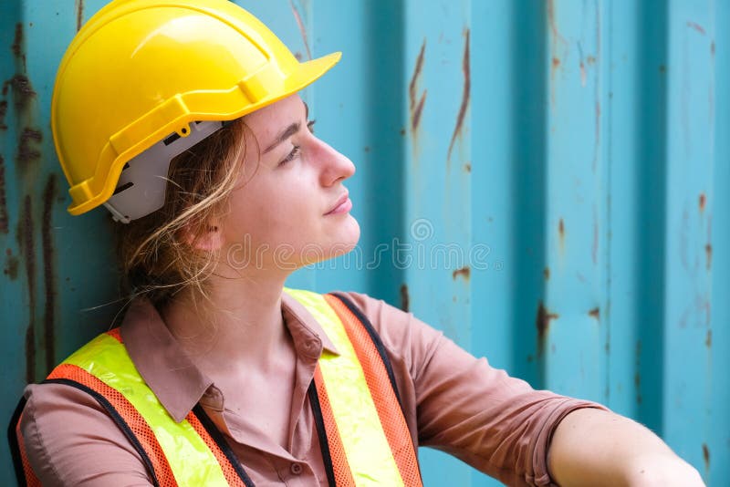 Pretty Engineer Worker Sitting on the Floor in Front of the Container ...