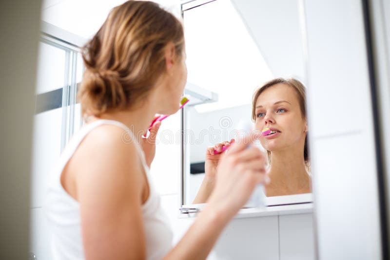 Pretty Female Brushing Her Teeth In Front Of Mirror Stock Image Image