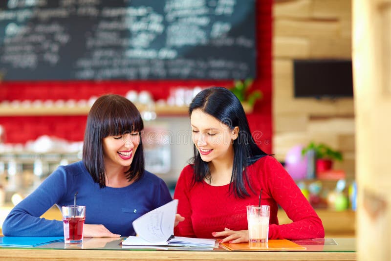 Pretty Female Friends Studying in Cafe Stock Photo - Image of people ...