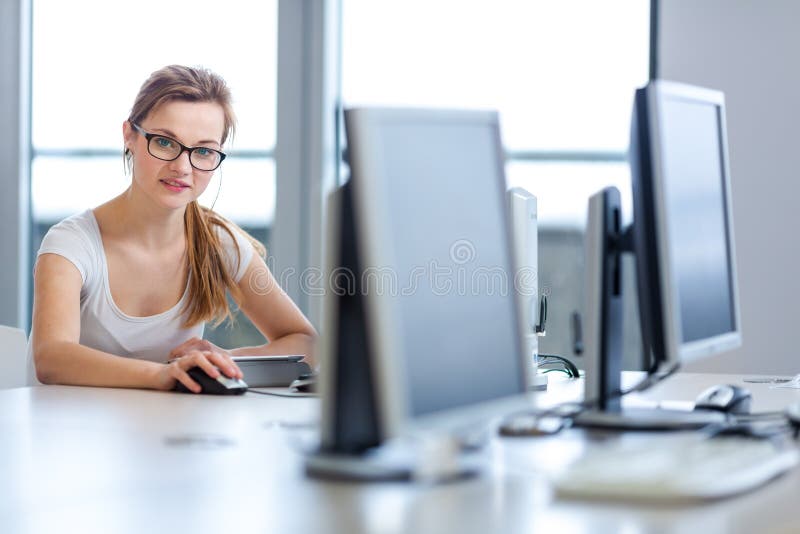 Pretty, Female Student Using Her Tablet Computer in a Study Room Stock ...