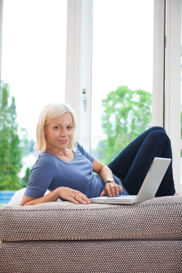 Female Using Computer Laptop on Desk at House Stock Image - Image of ...