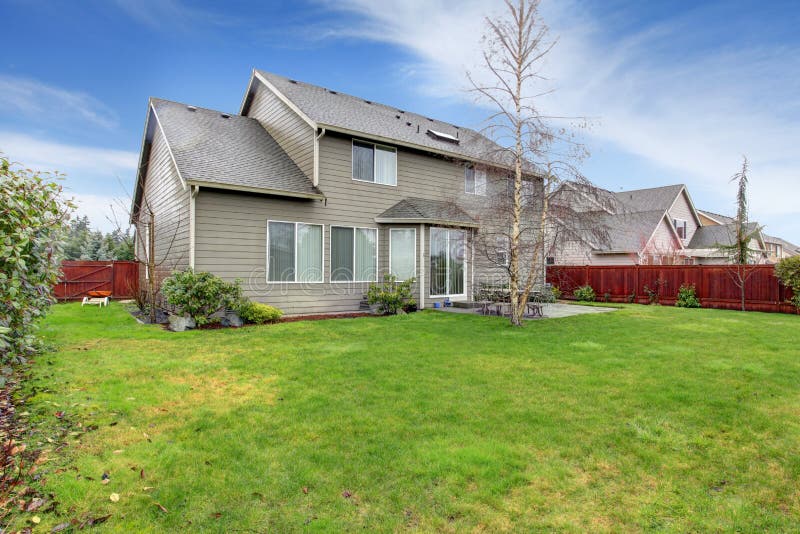 Pretty Fenced Green Backyard with Small Patio Stock Image - Image of ...