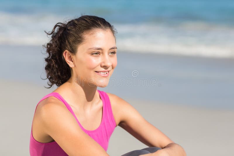 Pretty Fit Brunette Sitting beside the Sea Stock Photo - Image of ...