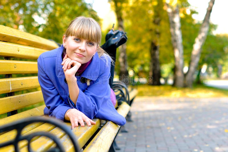 Pretty Girl in Blue Coat on Bench Stock Photo - Image of coat, beauty ...