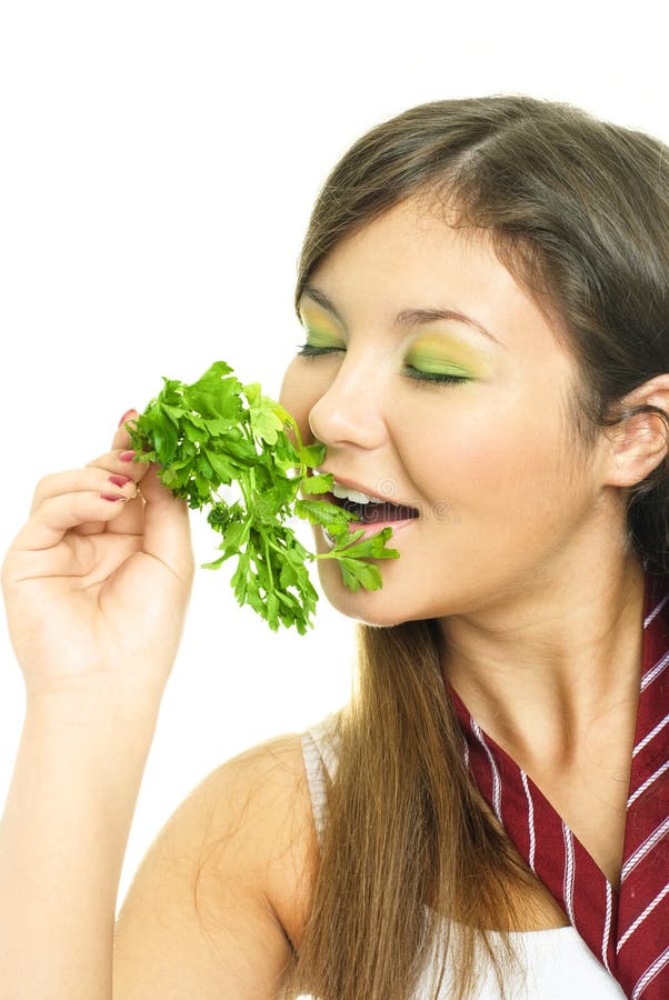 Pretty girl eating parsley stock photo. Image of joyful - 9168874