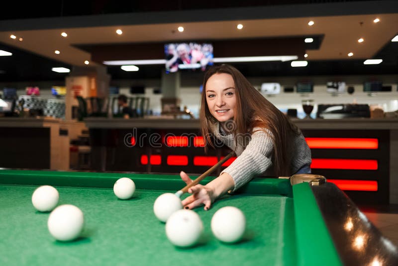 Pretty Girl Getting Ready To Hit a Ball in a Billiard Table Stock Photo ...