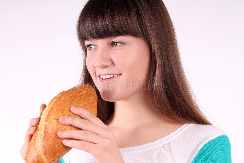 Pretty Girl Holding and Biting Loaf of Bread Stock Photo - Image of ...