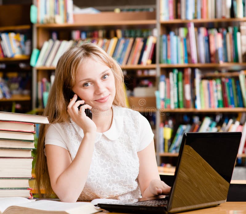 Pretty Girl in Library Typing on Laptop and Talking on the Phone Stock ...