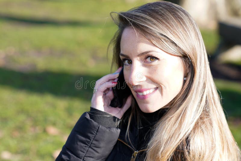 Pretty Girl Looking with Mobile Phone Call and Smiling Stock Photo ...