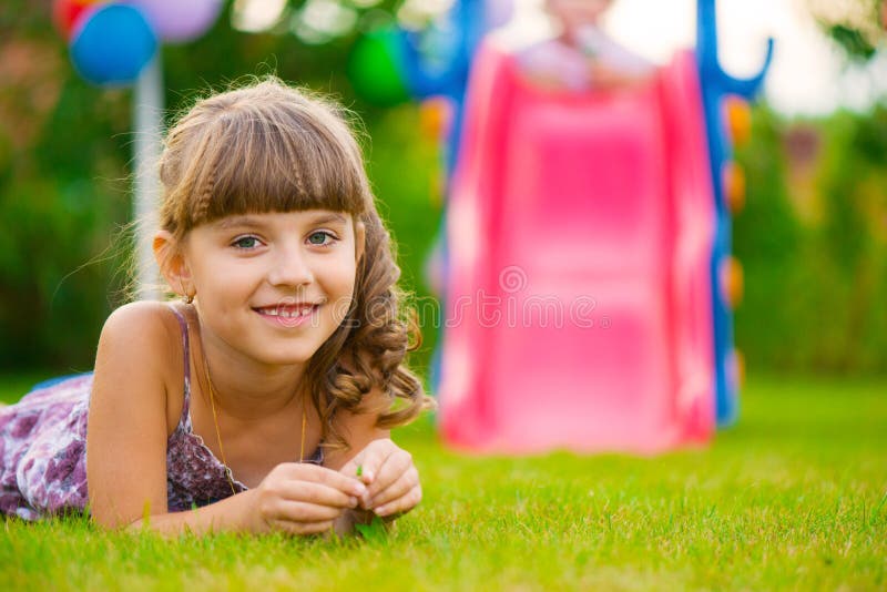 Pretty Girl Lying on Grass at Playground Stock Photo - Image of ...