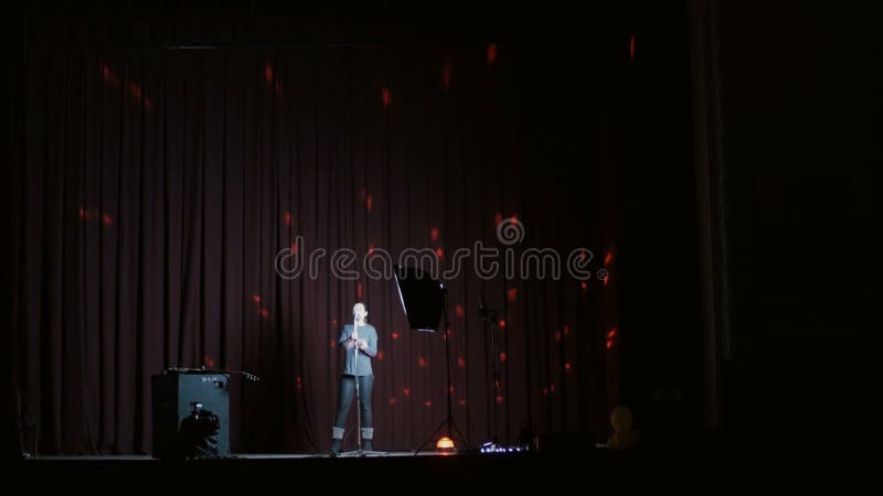 Pretty Girl Singing on a Stage at a Party with Lights on Background ...