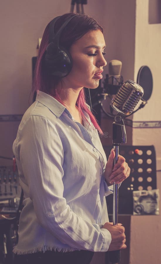 Pretty Girl Singing into Studio Microphone. Stock Photo - Image of face ...