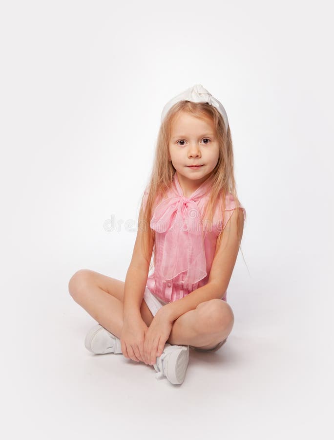 Pretty Girl Sitting on the Floor. Bright Portrait Made in the Studio ...