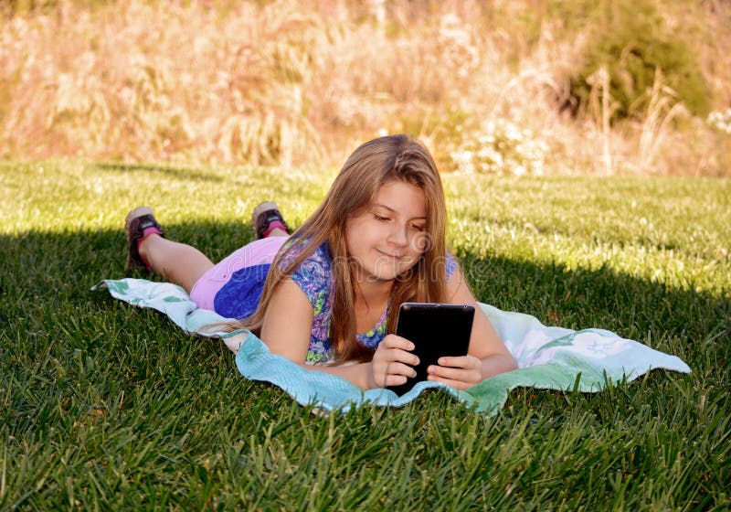 Pretty Girl Using Her Tablet. Stock Image - Image of cute, girl: 47095423