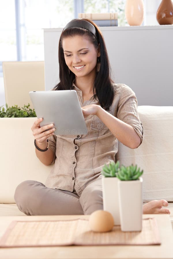 Pretty Girl Using Tablet at Home Smiling Stock Photo - Image of ...