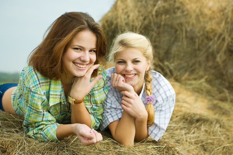 Pretty girls on hay stock image. Image of complexion - 16125507