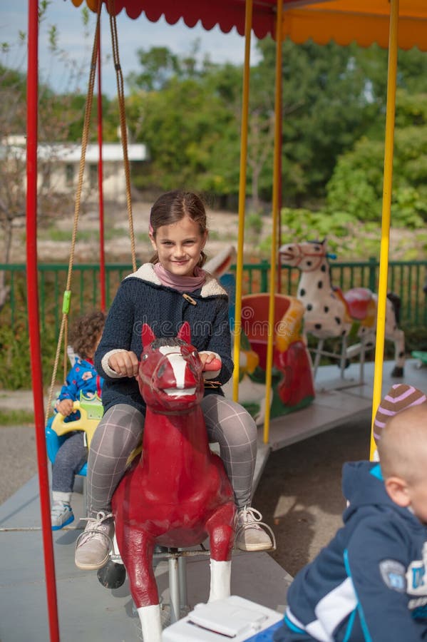 Pretty Girls Riding Merry-go-round Stock Photo - Image of park, merry ...