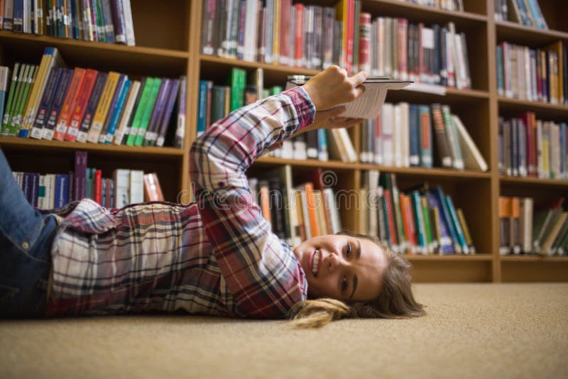 Pretty Happy Student Lying on Library Floor Reading Book Stock Image ...