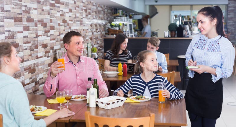 Hospitable Waitress Helping Handsome Man with Menu, Taking Order in ...
