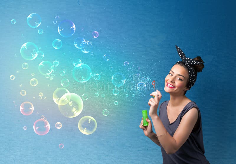 Pretty Lady Blowing Colorful Bubbles on Blue Background Stock Photo ...