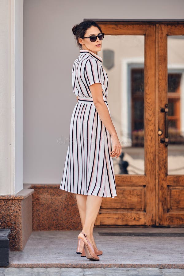 Pretty Lady in Striped Dress Approaching the Door Stock Photo - Image ...