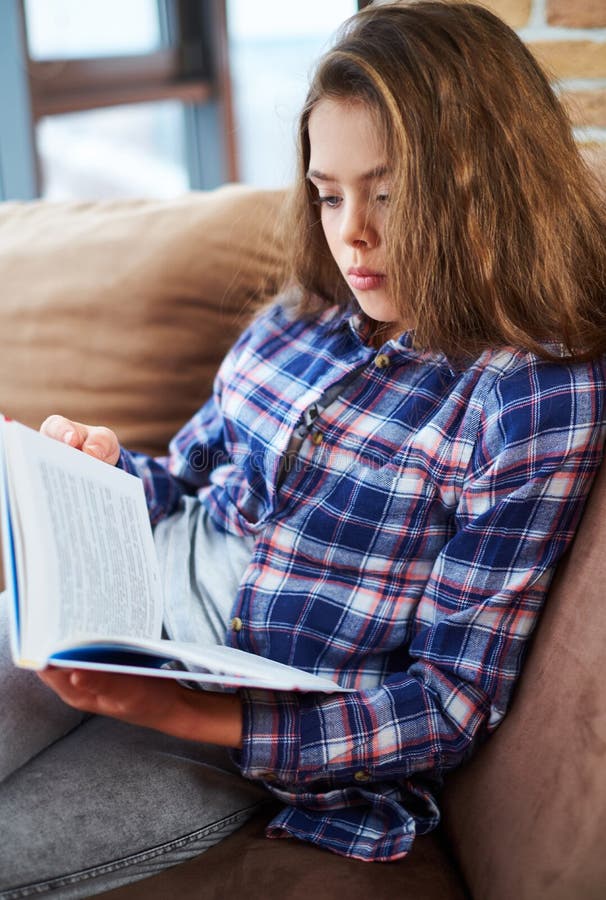 Pretty Little Girl Reading Book on a Couch Stock Image - Image of book ...
