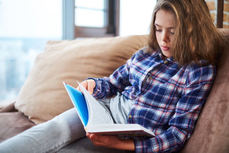 Pretty Little Girl Reading Book on a Couch Stock Photo - Image of ...