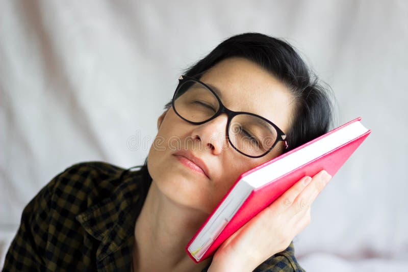 A Pretty Middle-aged Brunette with Glasses is Dozing with Fatigue, Her ...