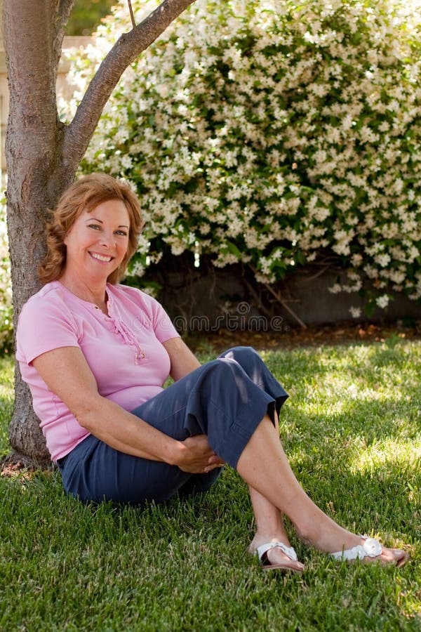 Pretty, Middle-aged Woman Sits Under Tree Stock Image - Image of aged ...