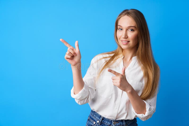 Pretty Nice Young Woman Pointing To Copy Space for Advertising Stock ...