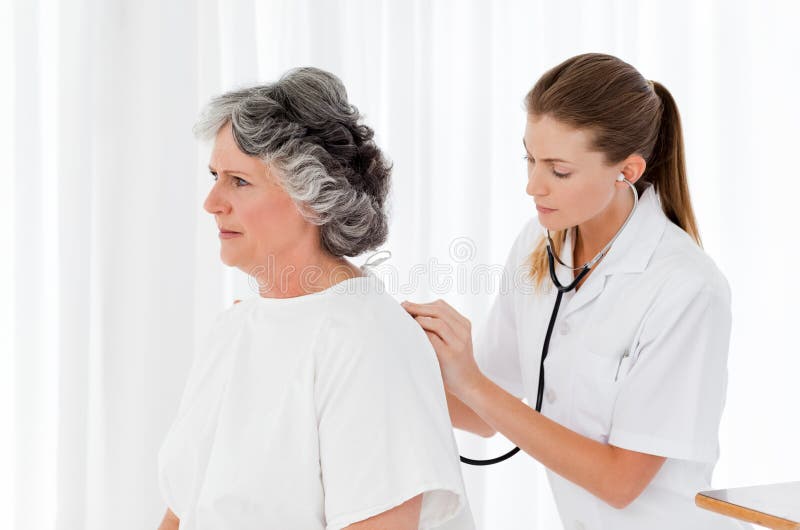 Pretty Nurse Taking the Heartbeat of Her Patient Stock Photo - Image of ...