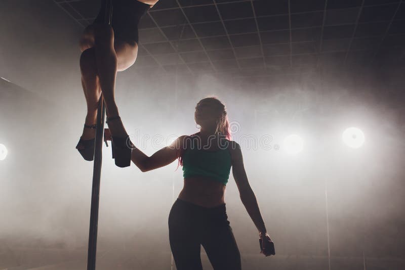 Pretty Pole Fitness Instructor Assisting One of Her Students during ...