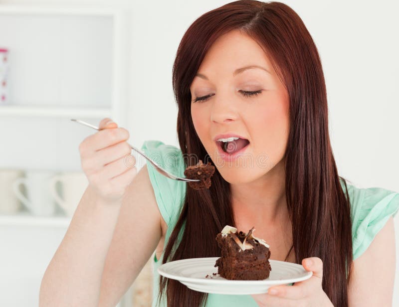 Pretty Red-haired Woman Eating Some Cake Stock Photo - Image of counter ...