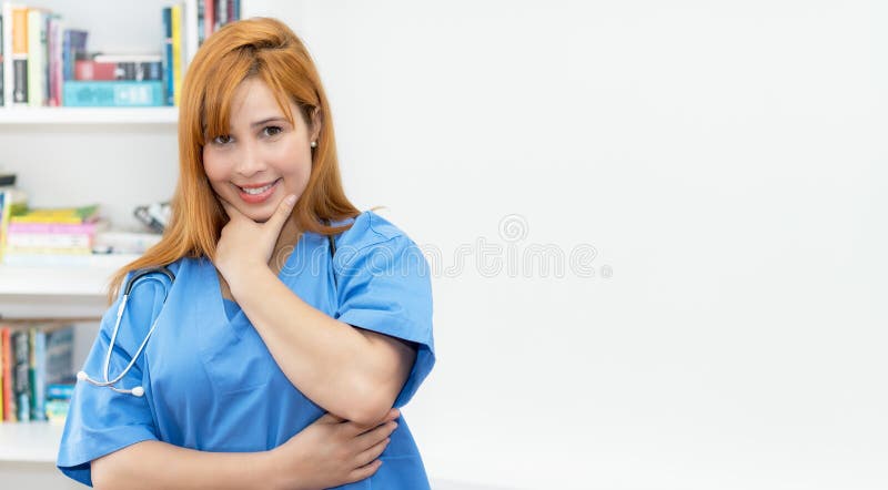 Pretty Redhead Nurse Looking at Camera at Work Stock Photo - Image of ...