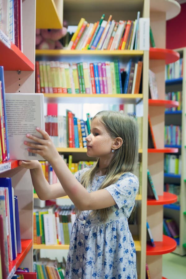 Pretty School Girl in Library Stock Photo - Image of childhood ...