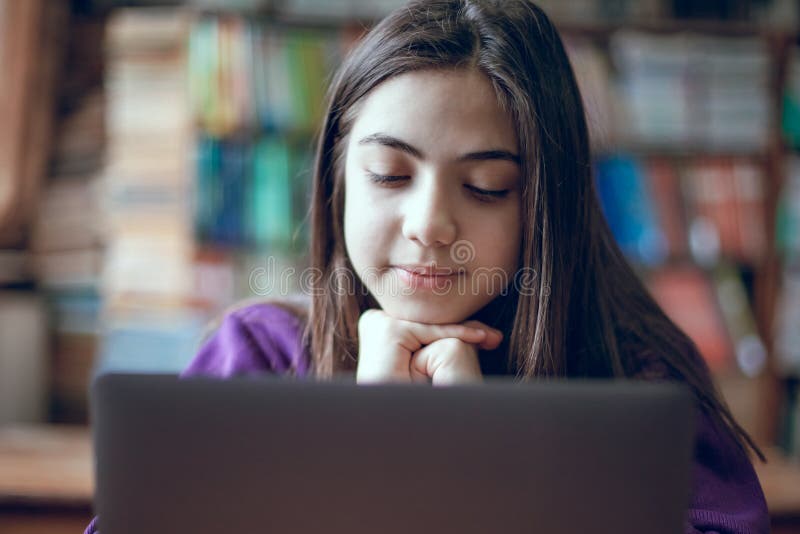 Pretty School Girl Studying in the School Library Using Laptop Stock ...