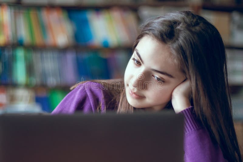 Pretty School Girl Studying in the School Library Using Laptop Stock ...