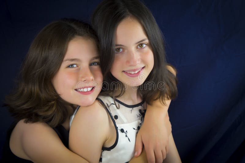 Two Sisters Smiling, Hugging and Kissing Stock Photo - Image of ...