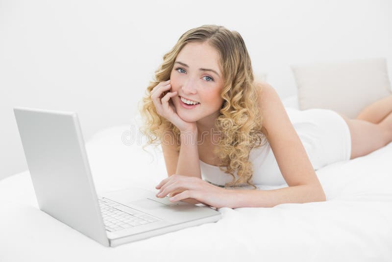 Pretty Smiling Blonde Lying on Bed Using Laptop Stock Photo - Image of ...