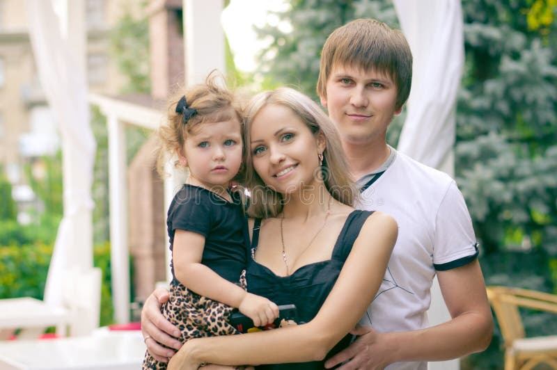 Pretty Smiling Family and Daughter Stock Photo - Image of dress ...