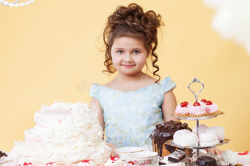 Pretty Smiling Girl Posing at Table with Desserts Stock Photo - Image ...